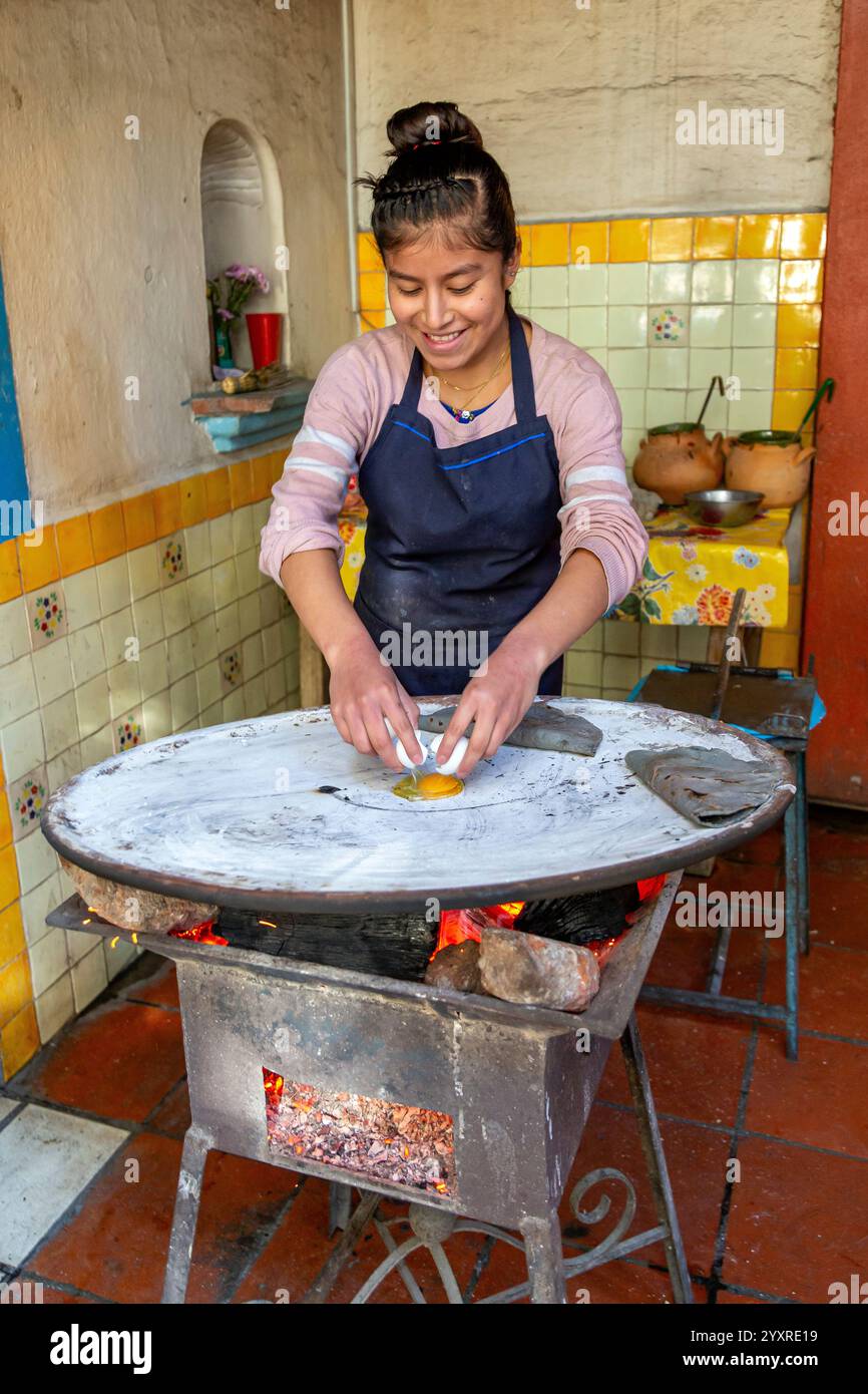 Traditional way to make tortillas at a hotplate. Santa María del Tule ...