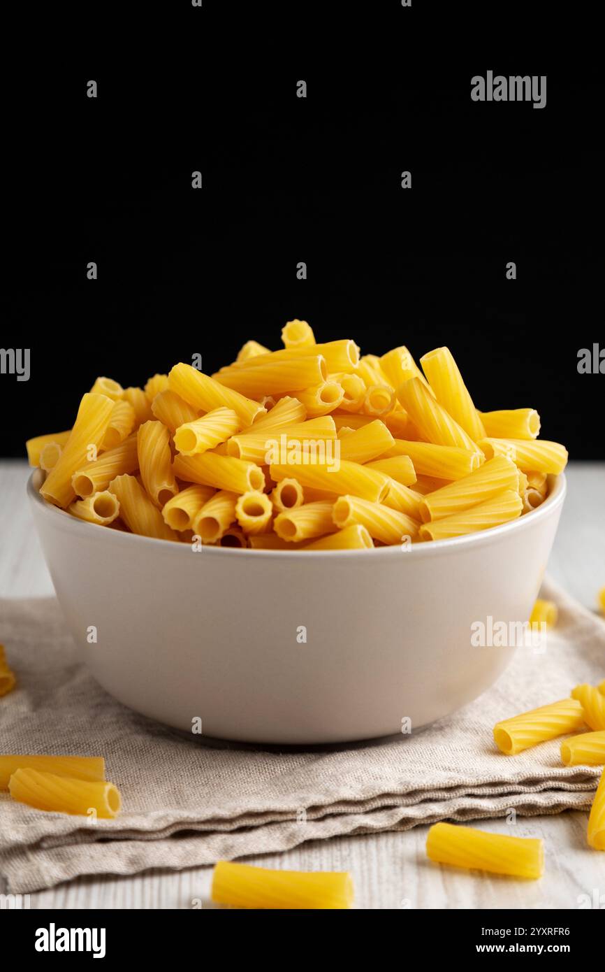 Dry Rigatoni Pasta in a Bowl, side view Stock Photo - Alamy