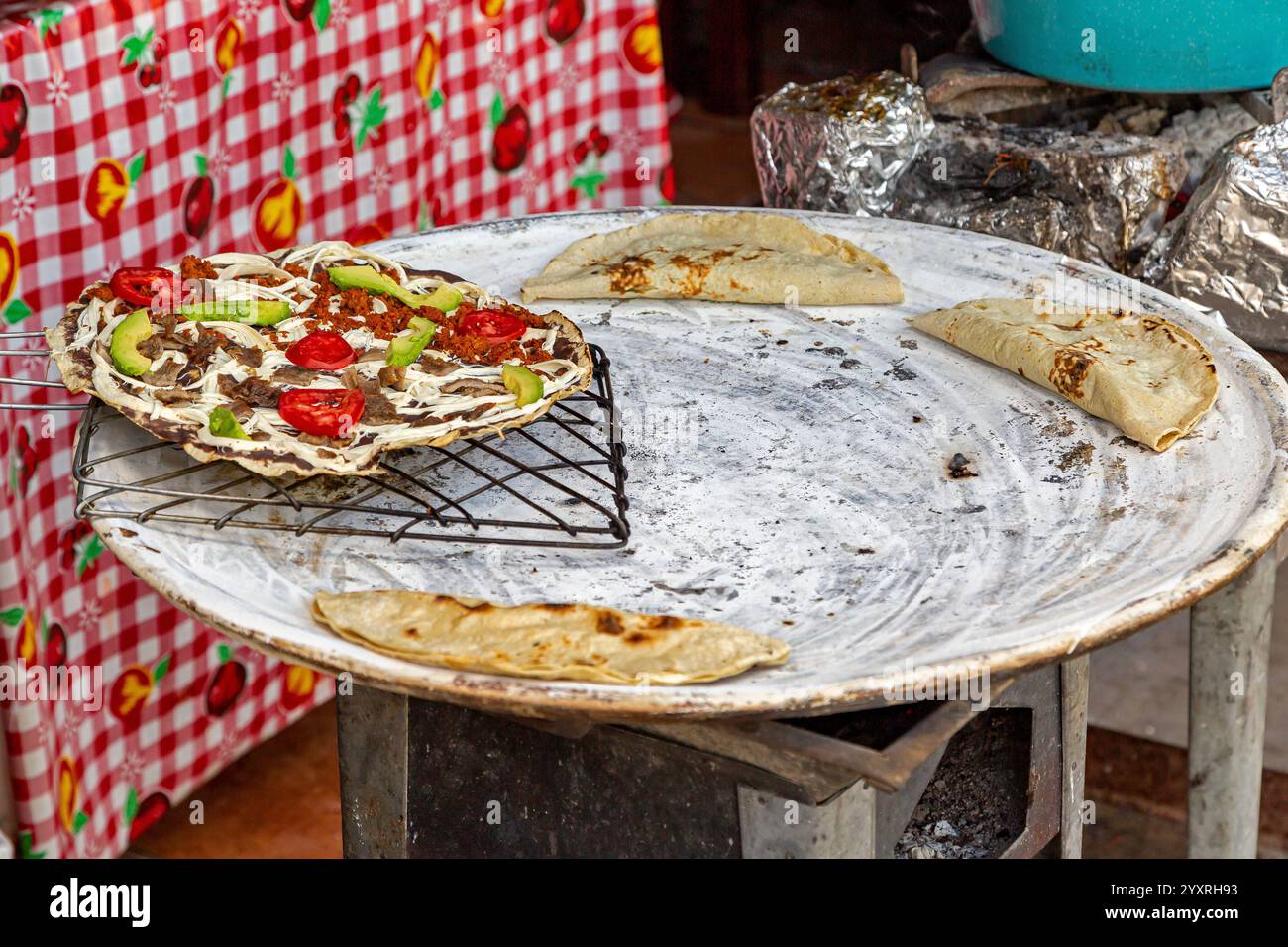Traditional way to make tortillas and tlayudas at a hotplate. Santa ...