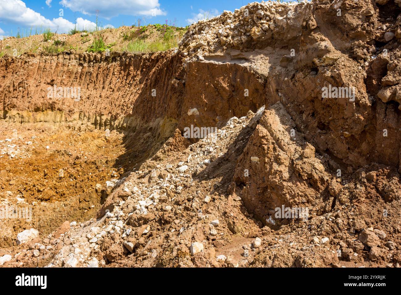 A layer of earth cut by an excavator in a quarry Stock Photo - Alamy