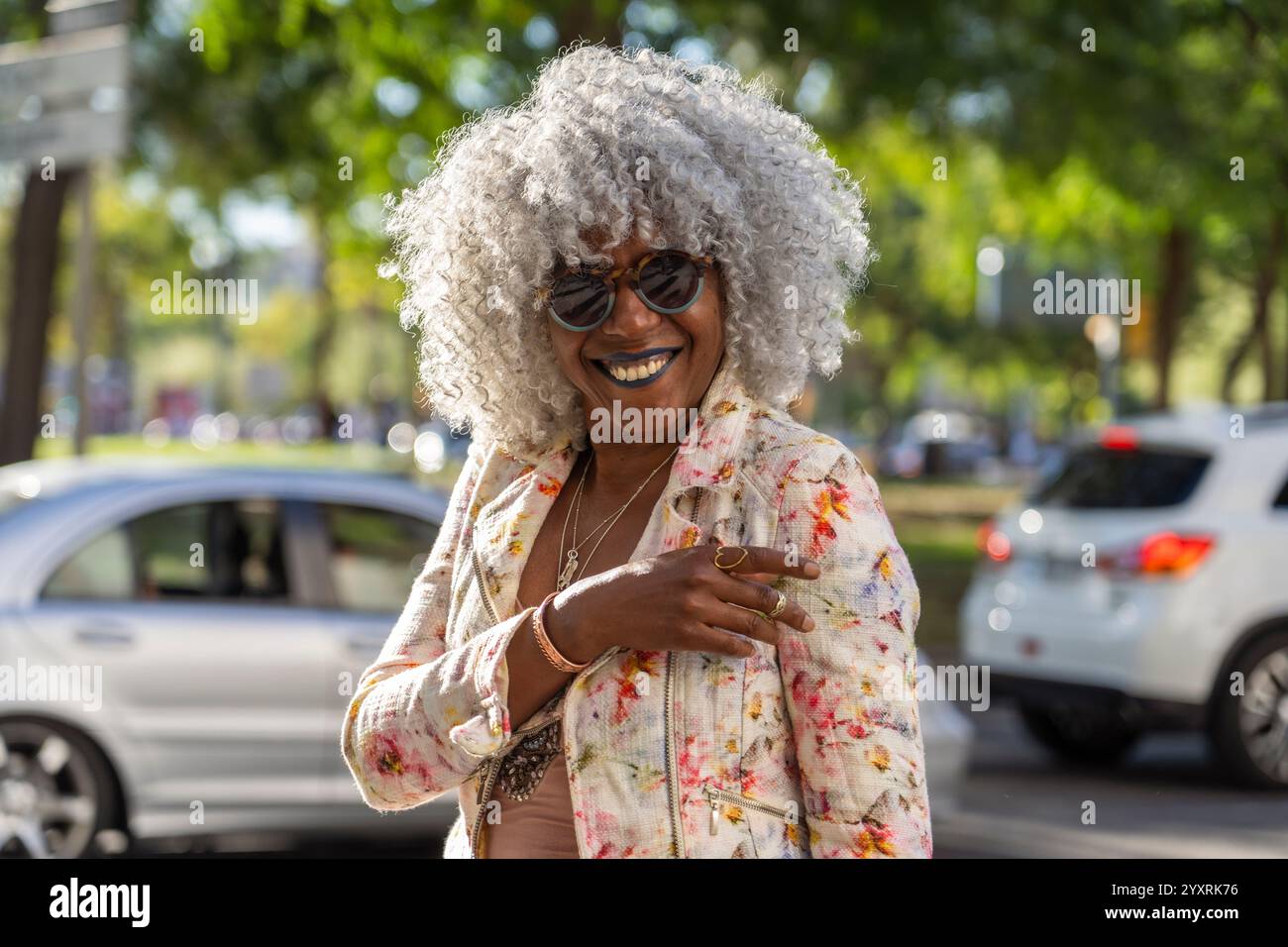 Self-confident, black lady with hoary afro hair and sunglasses smiling ...