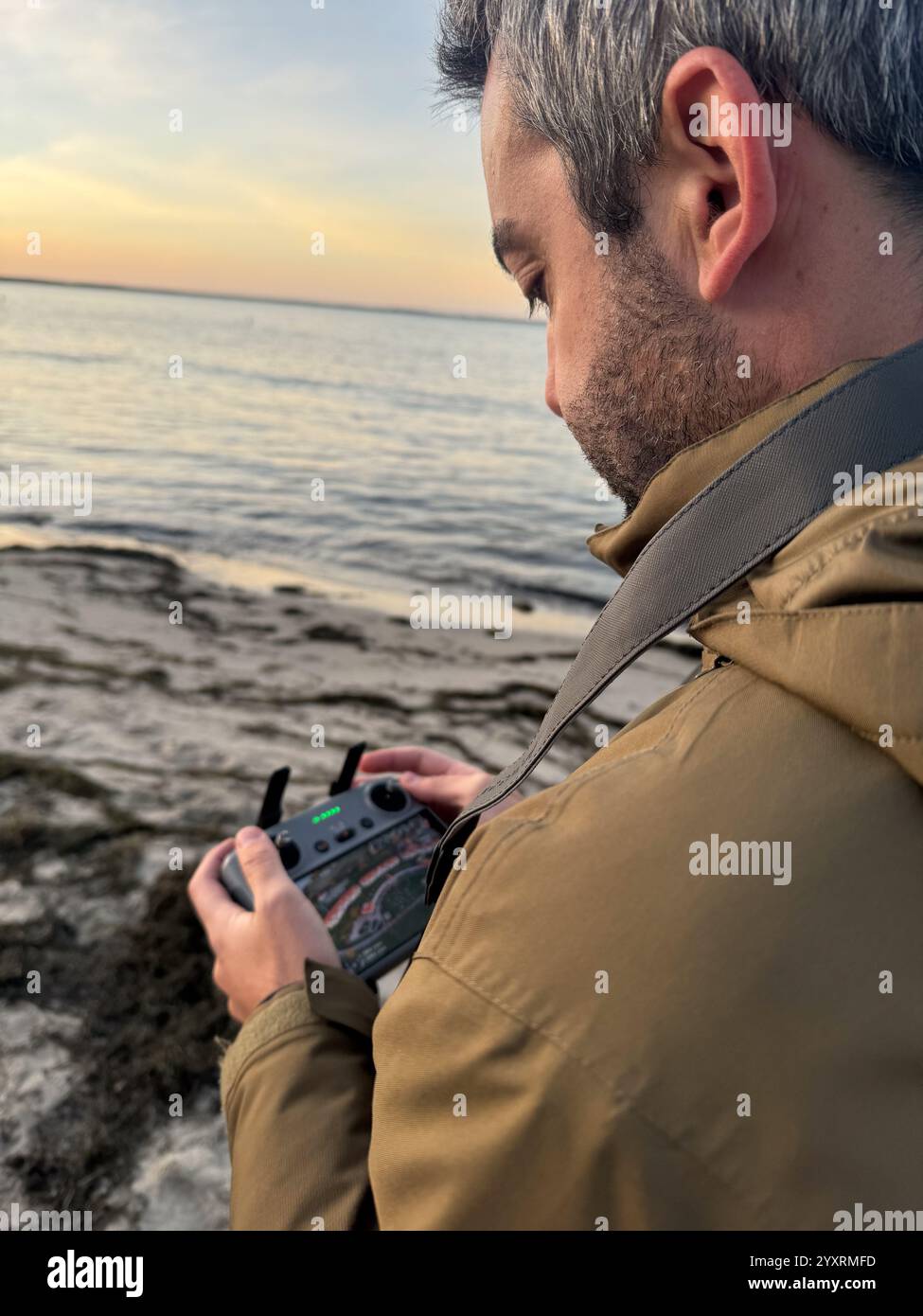 Drone pilot at the beach during sunset Stock Photo - Alamy