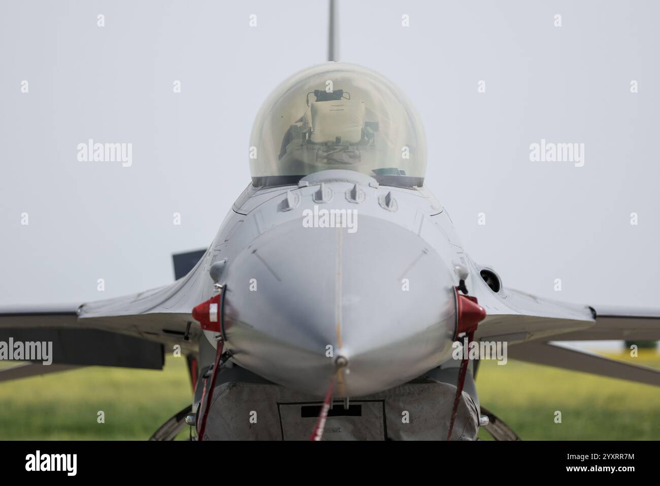 Fighter jet in parking position with red remove before flight ribbon ...