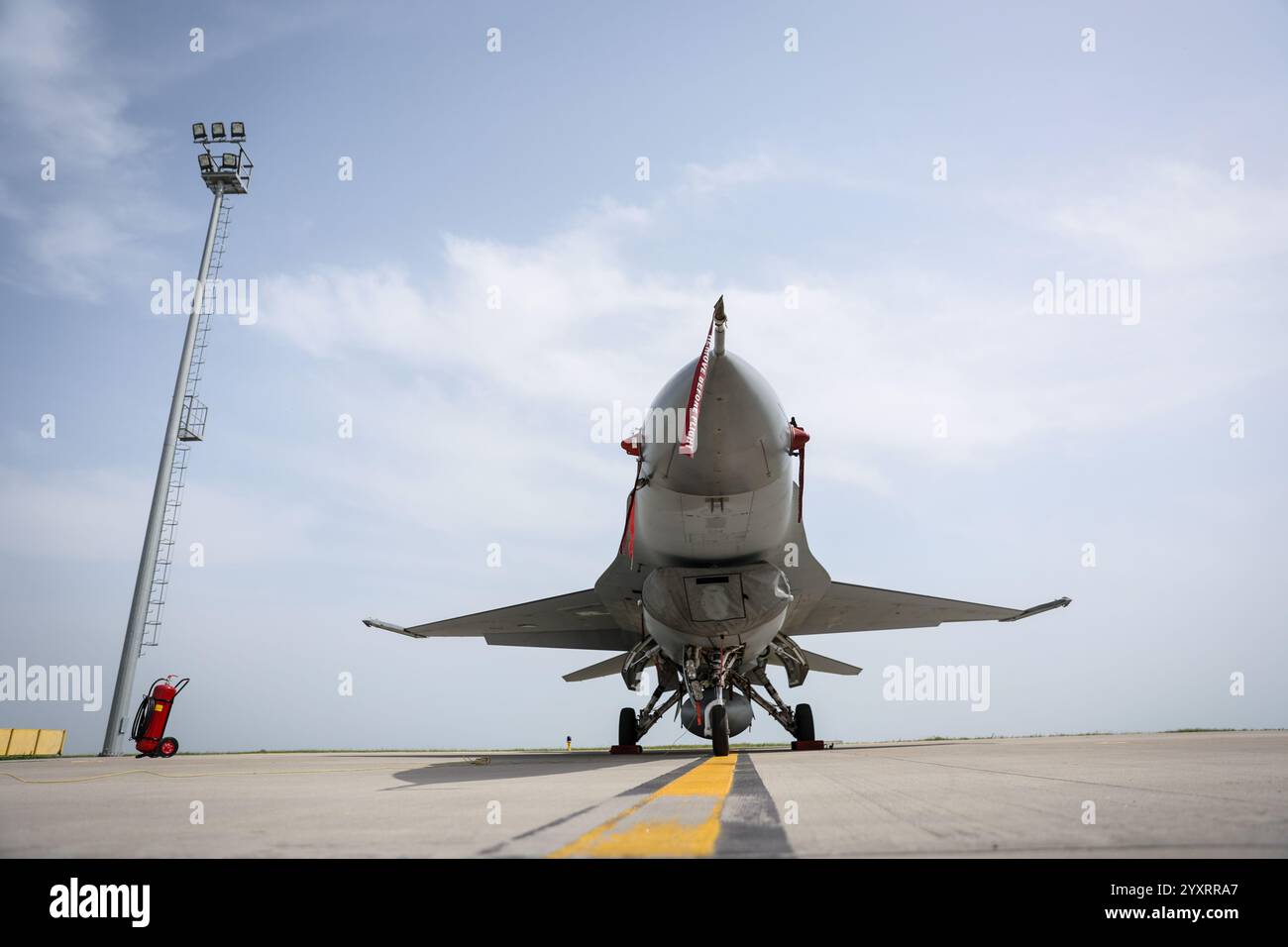 Fighter jet in parking position with red remove before flight ribbon ...