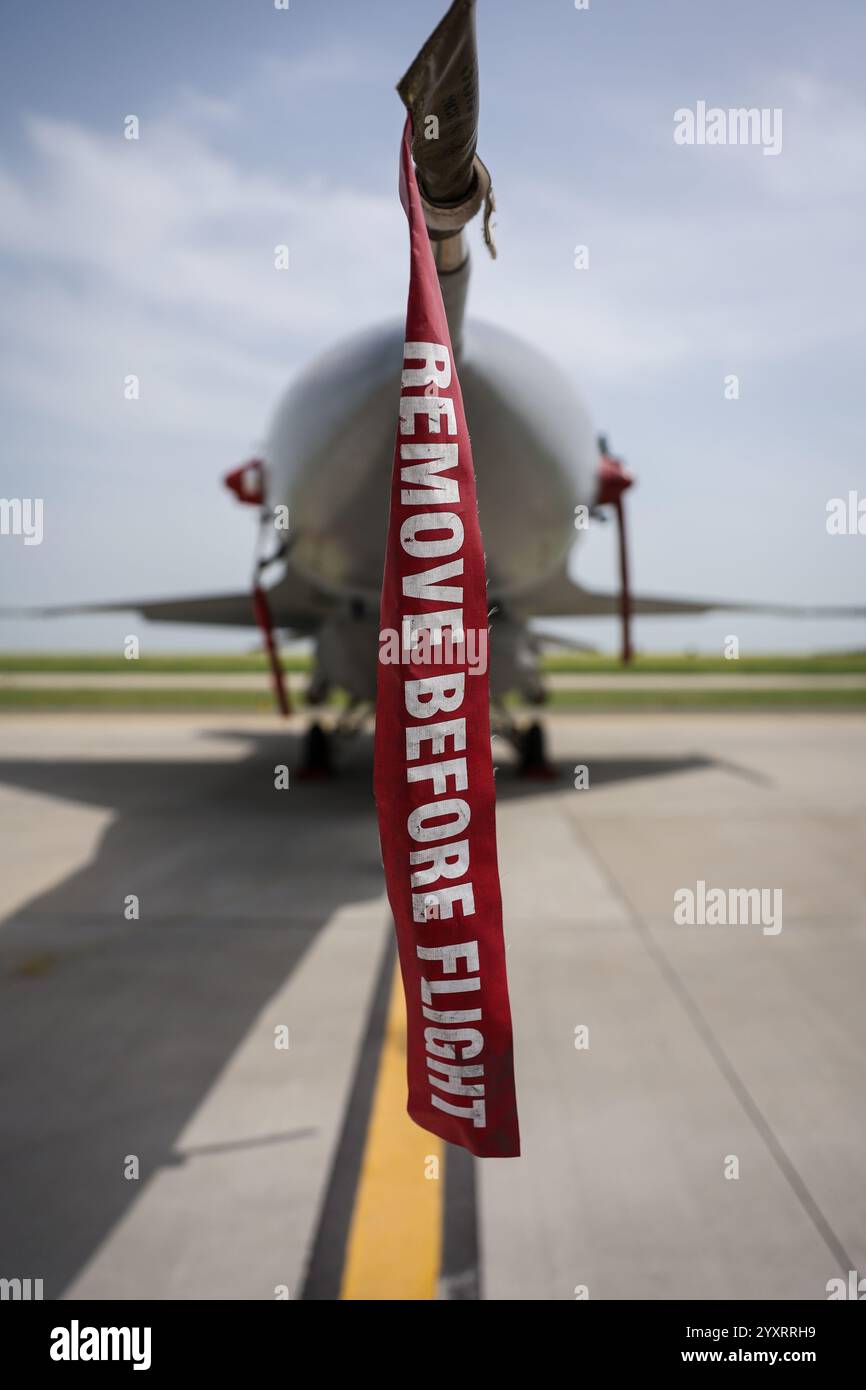 Remove before flight ribbon safety on a fighter jet Stock Photo - Alamy