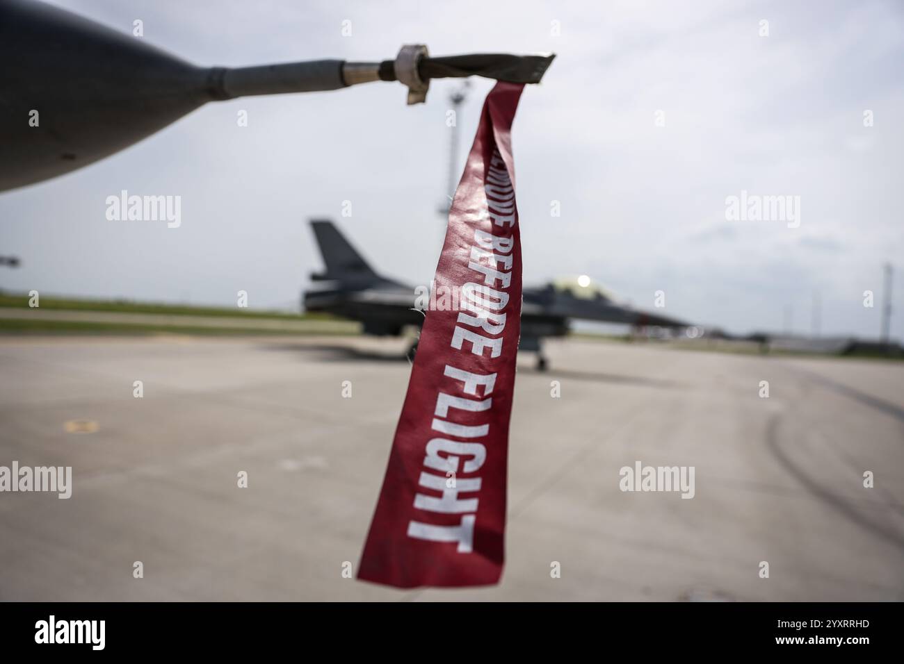 Remove before flight ribbon safety on a fighter jet Stock Photo - Alamy