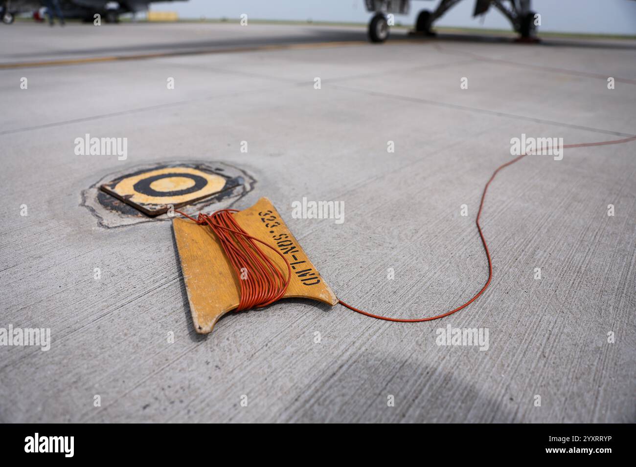 Electrical grounding cables are seen on a runway. Military fighter ...