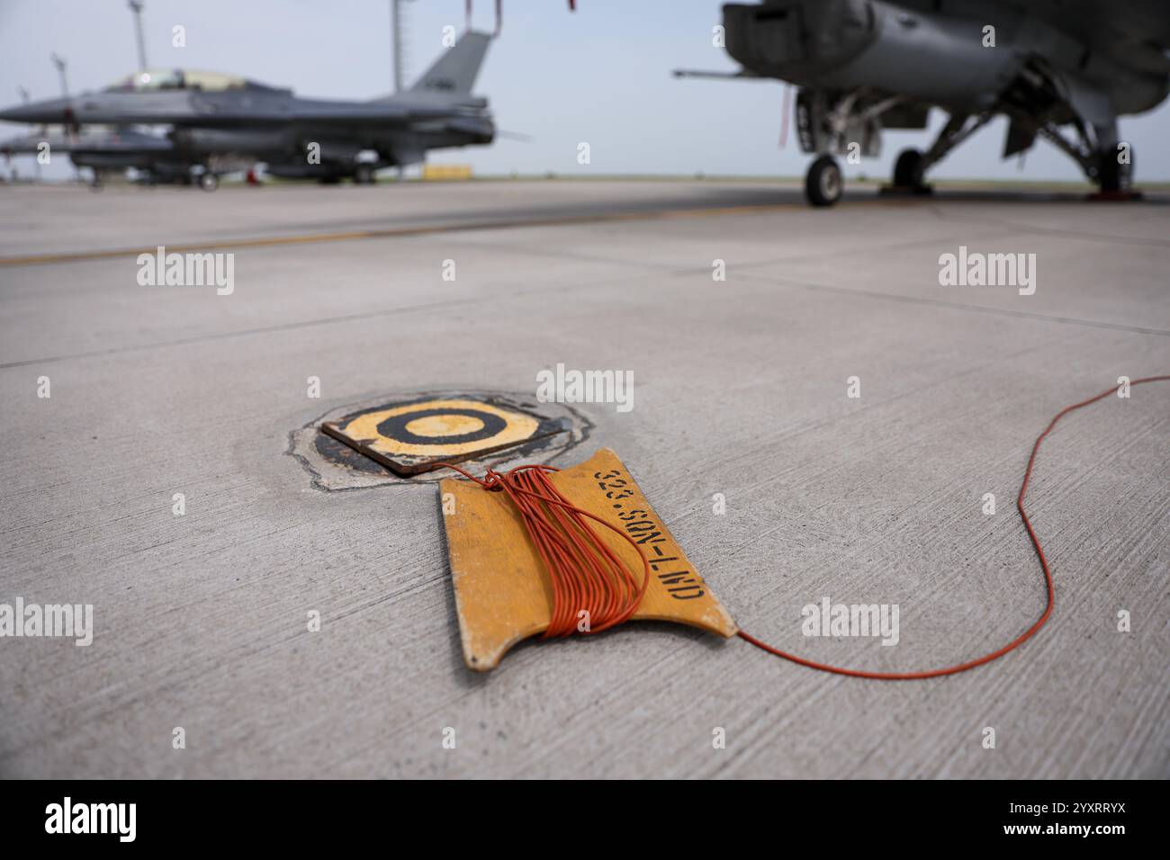 Electrical grounding cables are seen on a runway. Military fighter ...