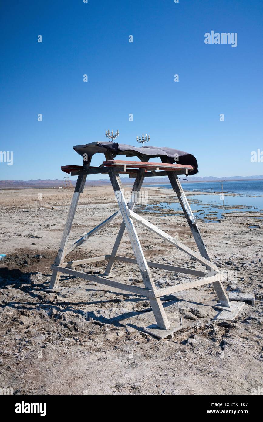 Very tall table with two candlelabra on it on the beach at Bombay Beach ...