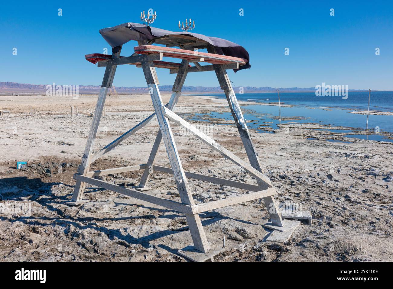 Very tall table with two candlelabra on it on the beach at Bombay Beach ...