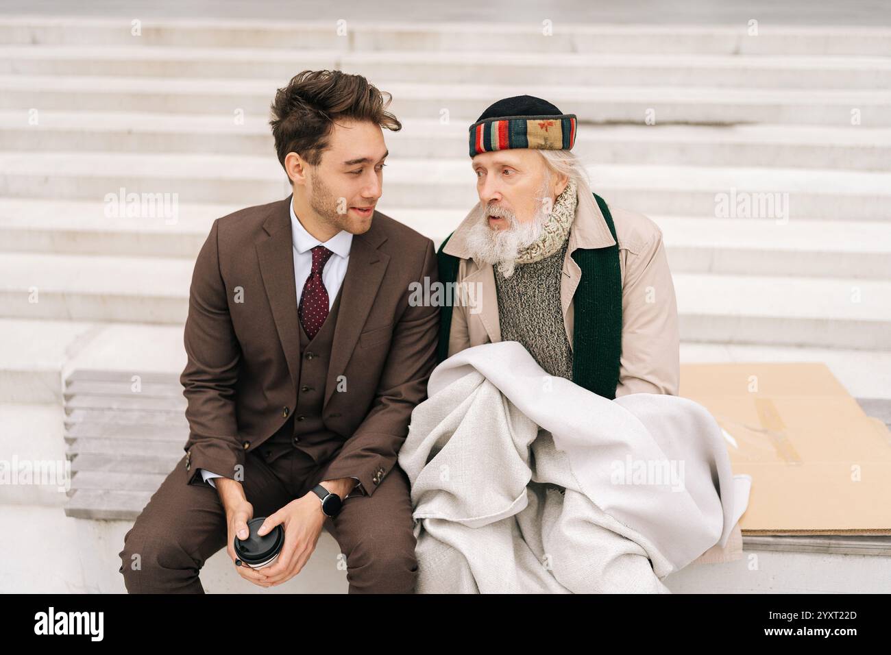 Kind handsome business man listening and smiling as talking with ...