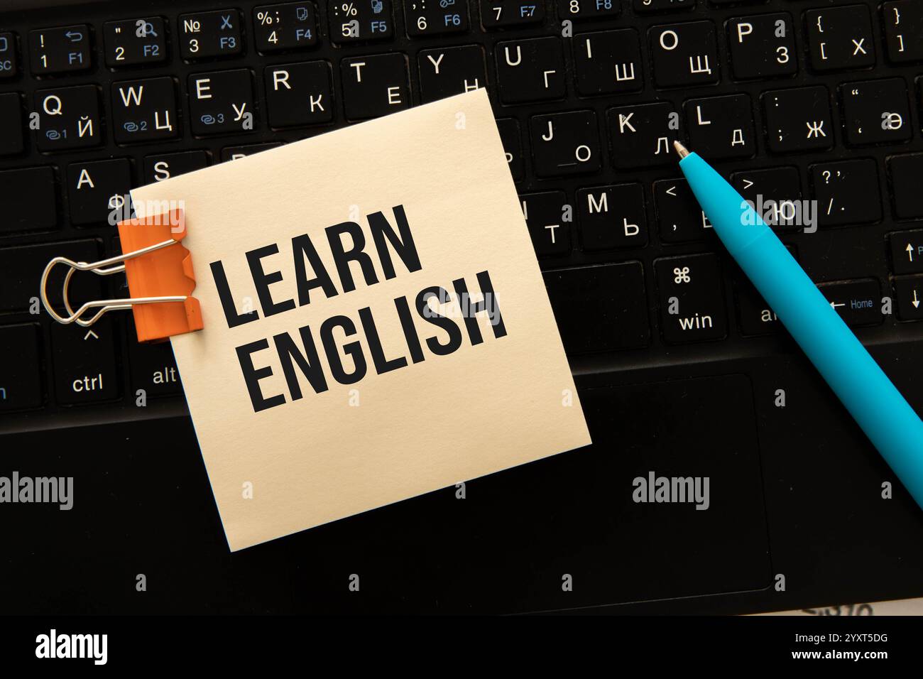 Learn english message written on wooden blocks with blue background ...