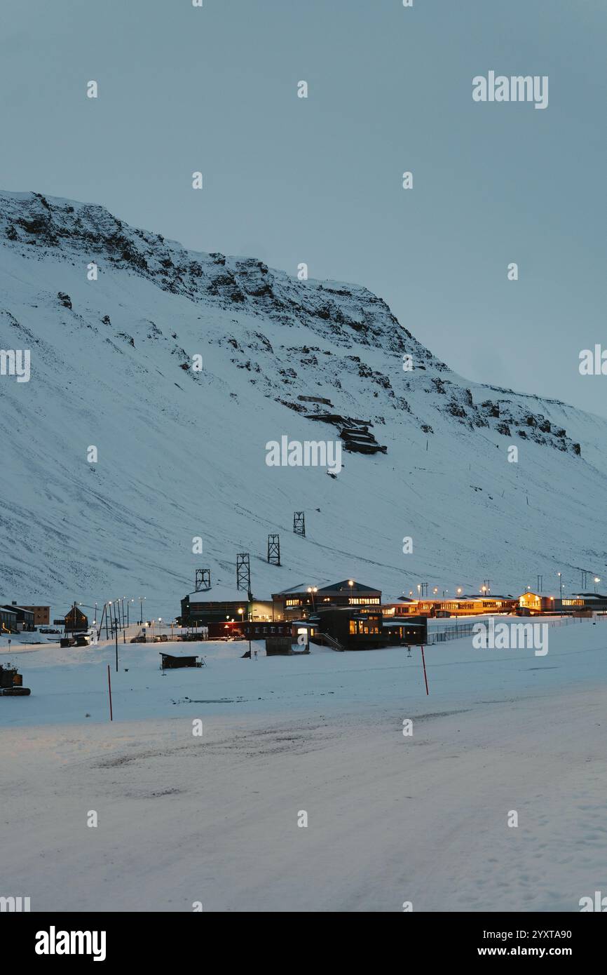 Buildings in valley between snowy mountains in Longyearbyen, Svalbard ...