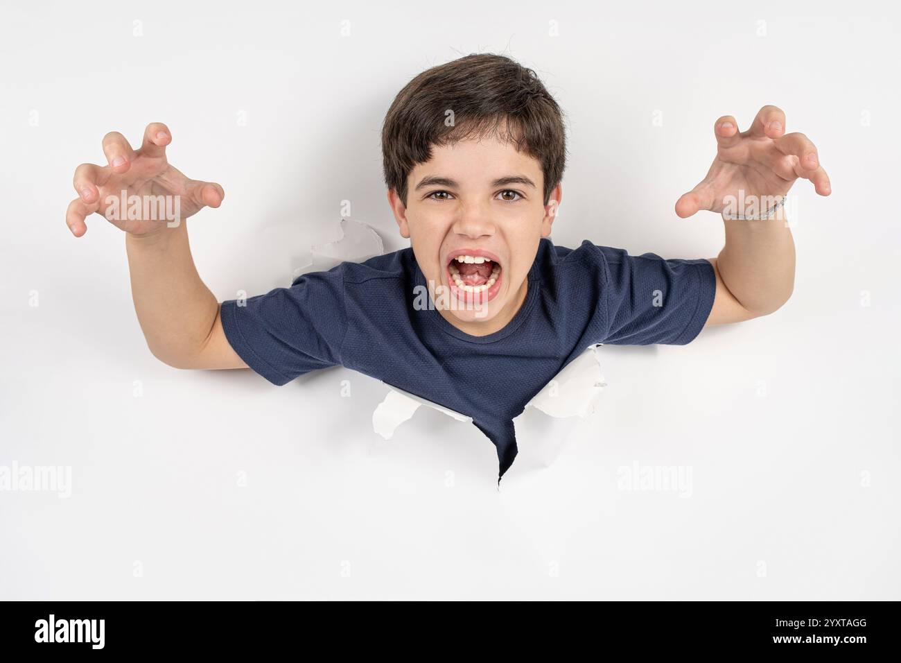 11 year old Brazilian child with his body through a white cardboard and ...