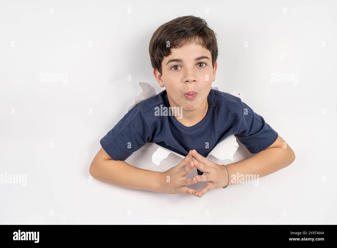 Brazilian 11 year old child with their body through a white cardboard ...