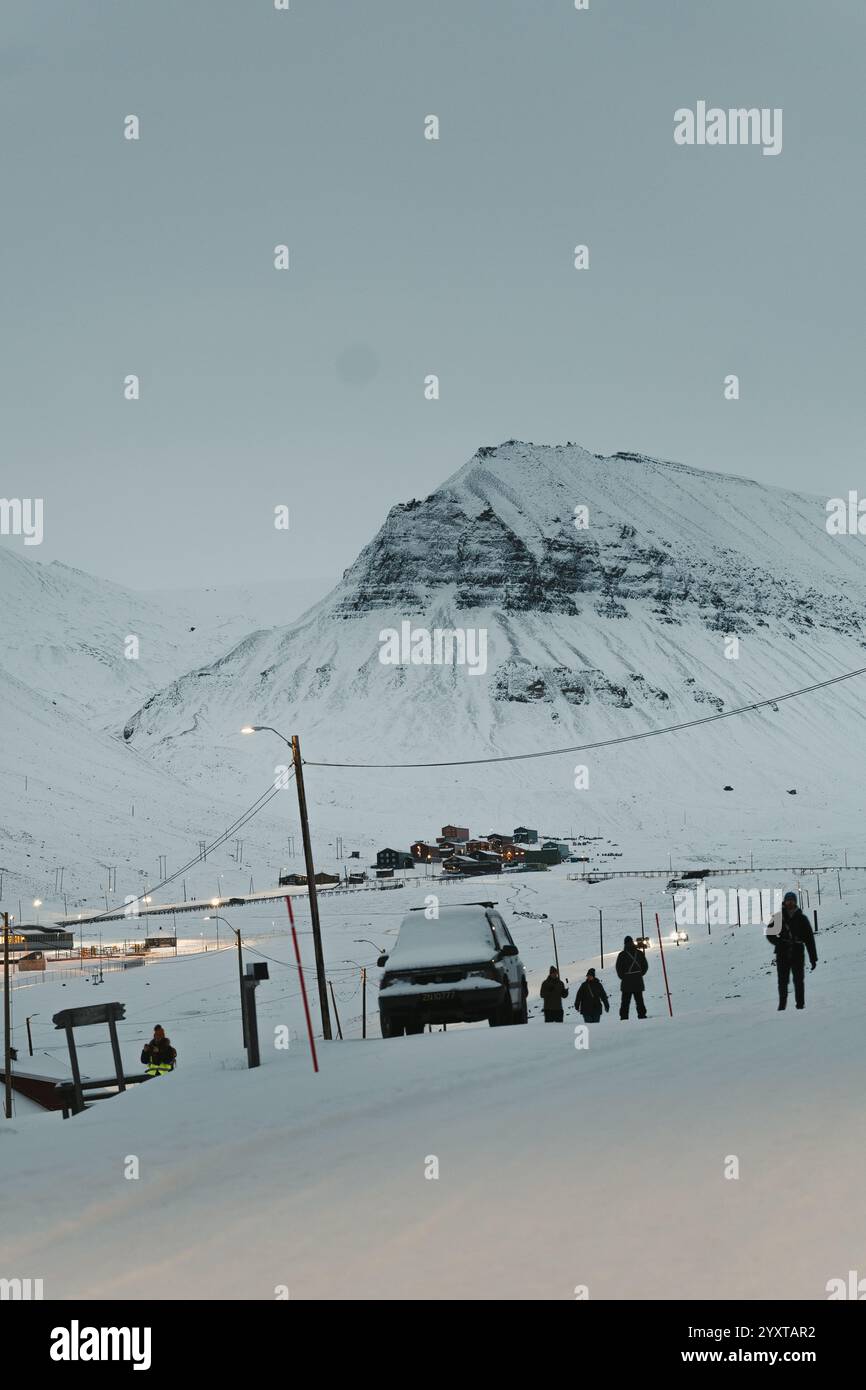 Nybyen and roads in front of snowy Sarkofagen mountain in Longyearbyen ...