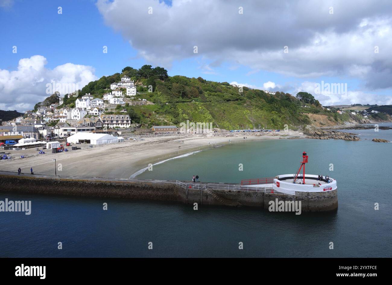 A landscape photograph showing the Harbour Mole and cliffs at East Looe ...