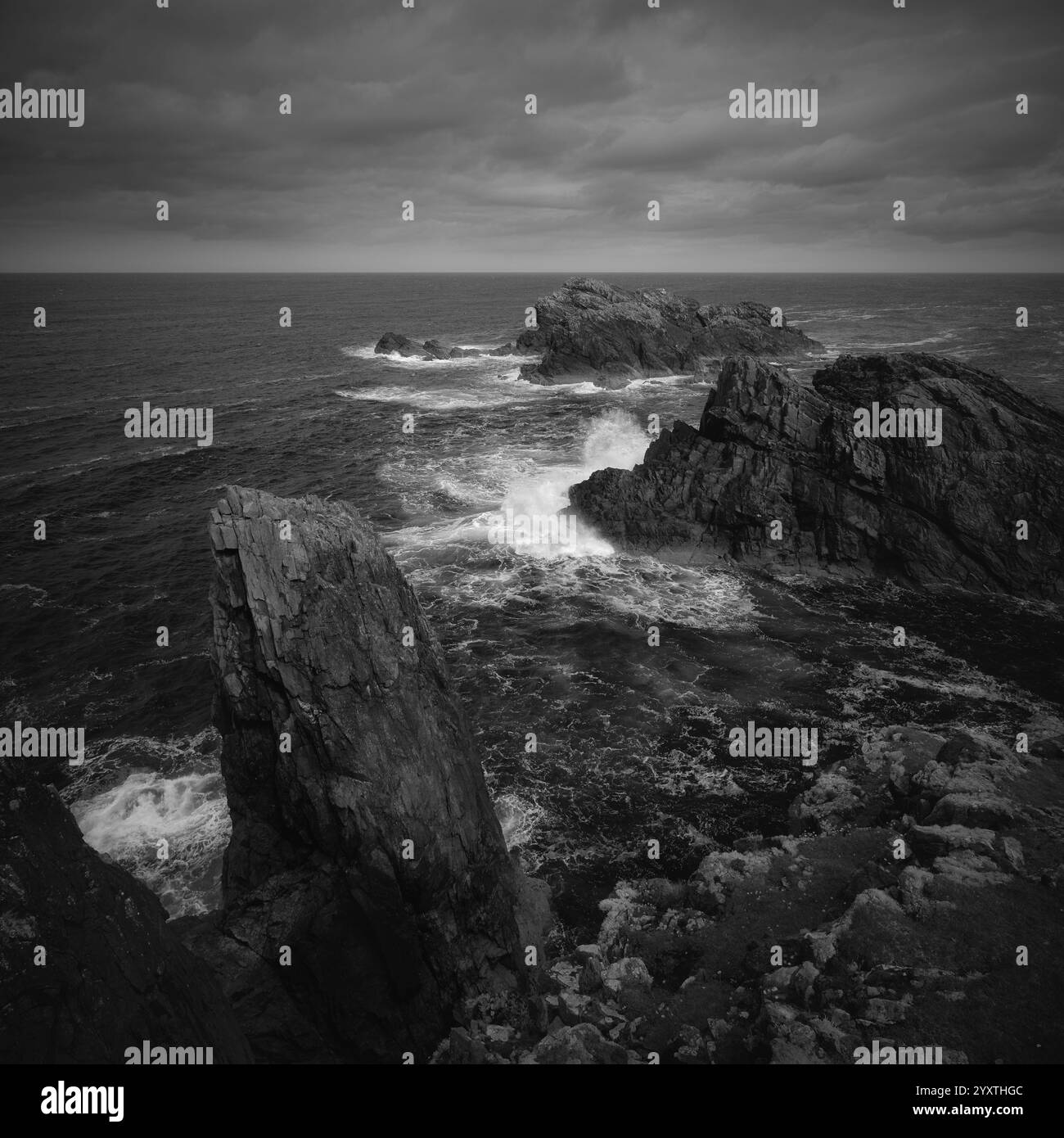 A rocky sea cove in the north of the Isle of Lewis. Black and white ...
