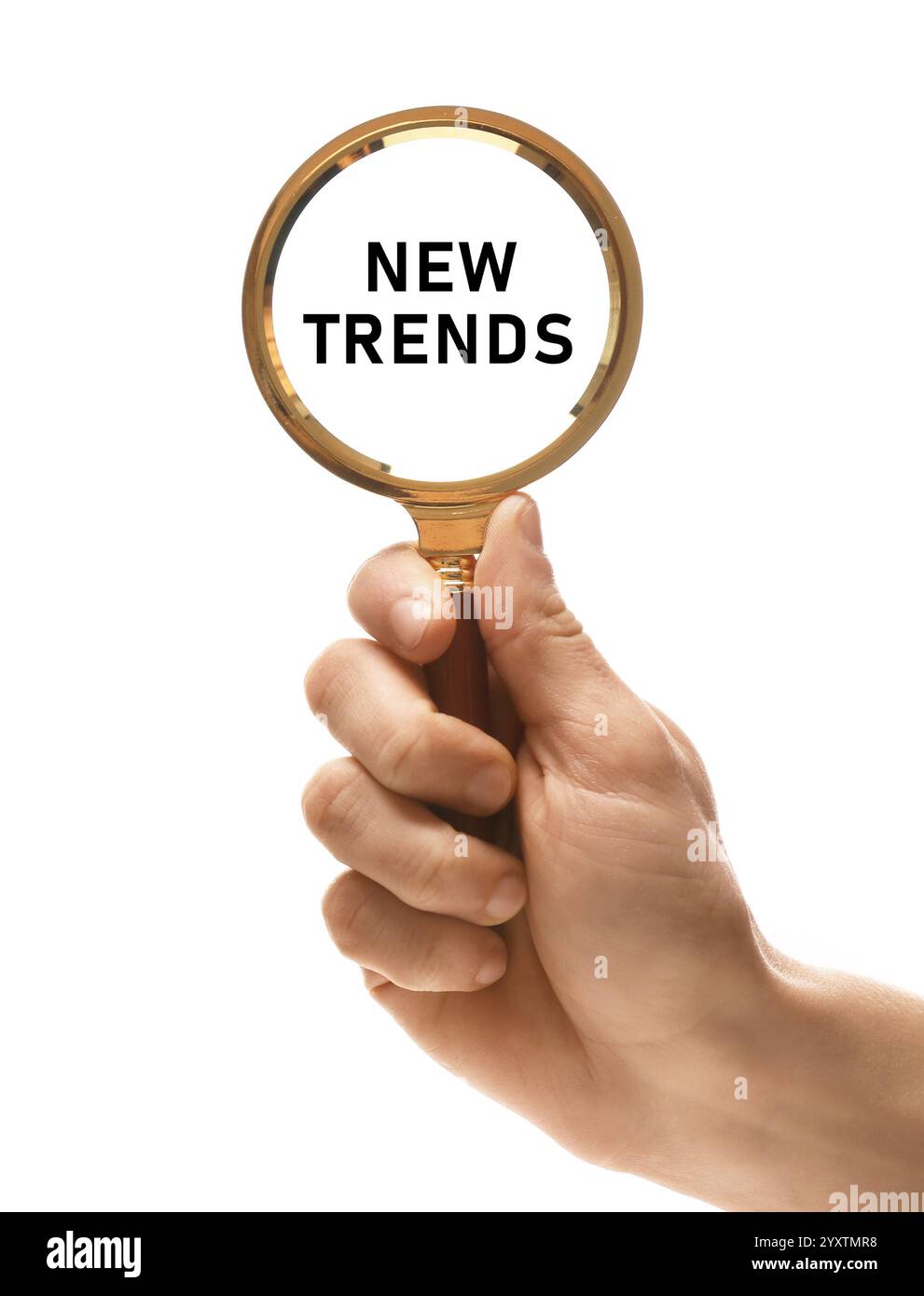 Woman looking at words New Trends through magnifying glass on white ...