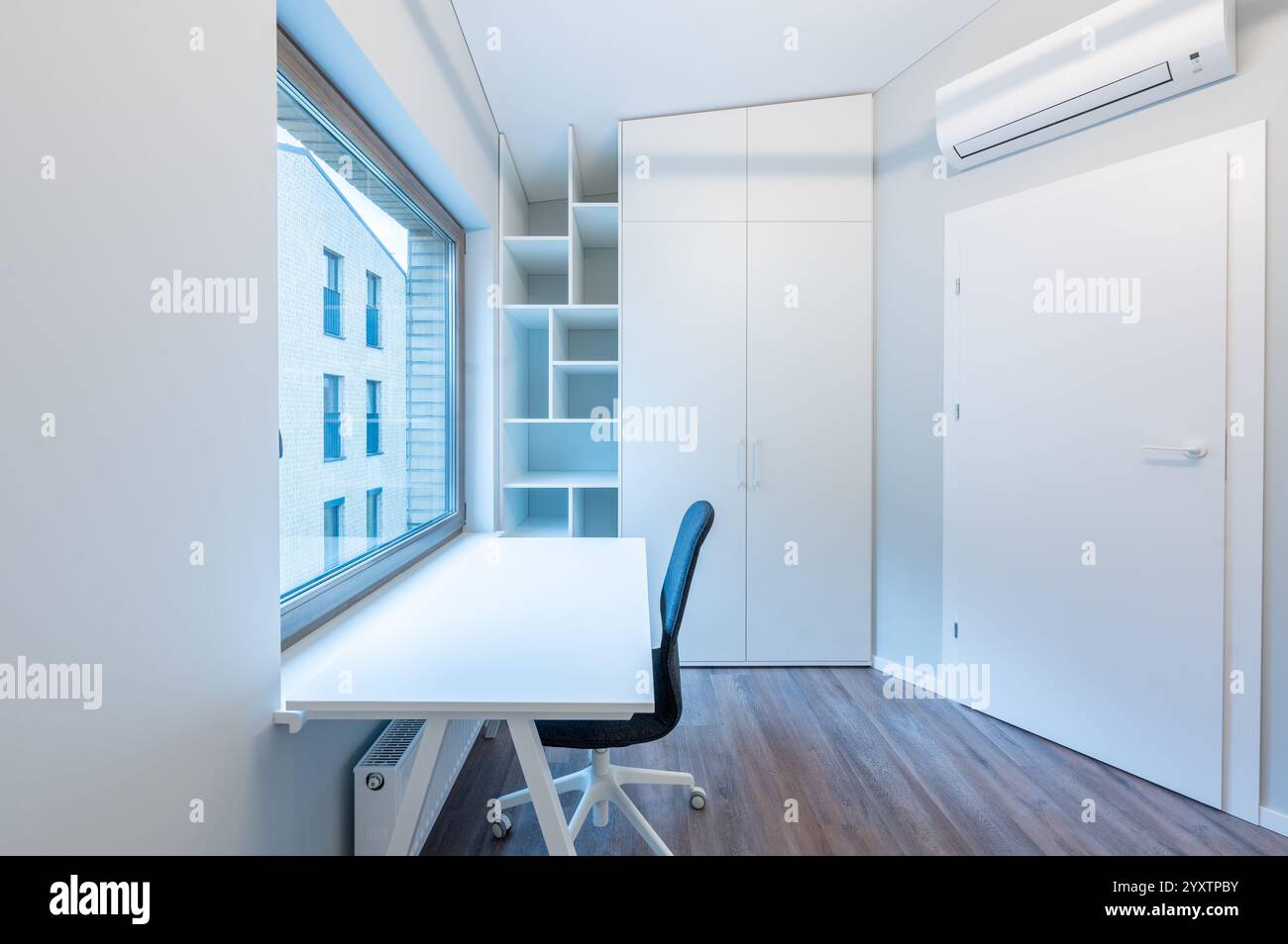 Bright and spacious home office featuring a white desk and chair, large ...