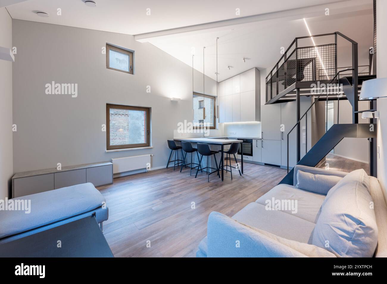 A sleek and contemporary loft apartment featuring an open kitchen ...