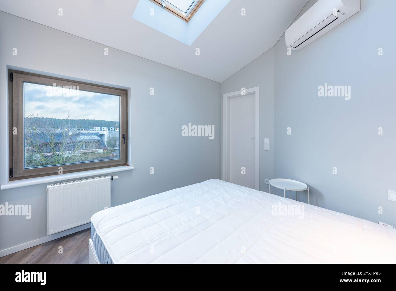 Bright and clean bedroom featuring a cozy bed, white built-in wardrobe ...