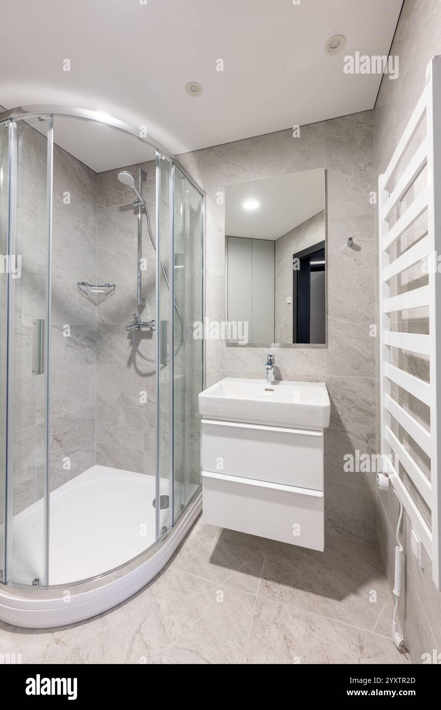 Contemporary bathroom featuring a glass-enclosed shower, a sleek white ...