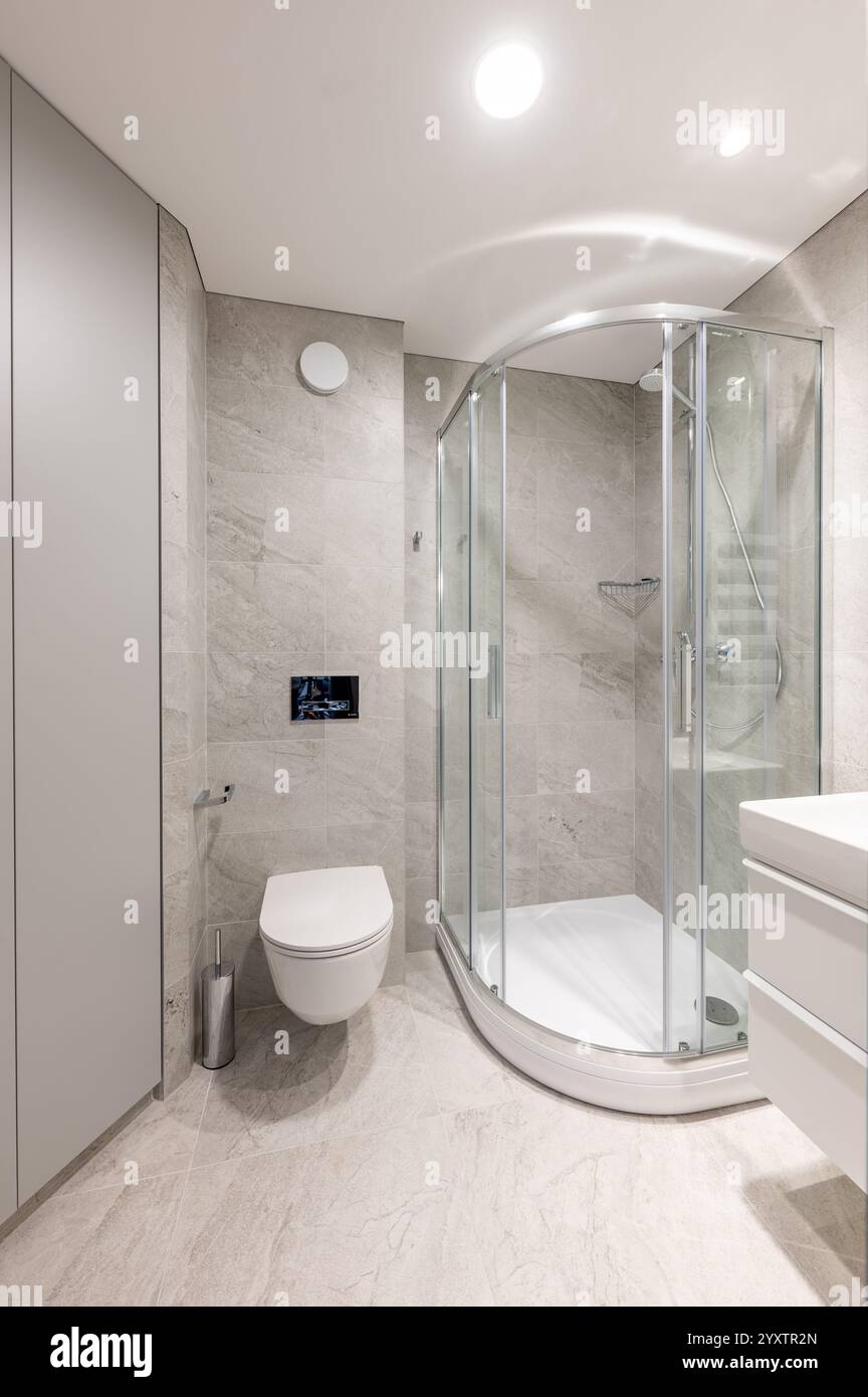Contemporary bathroom featuring a glass-enclosed shower, a sleek white ...