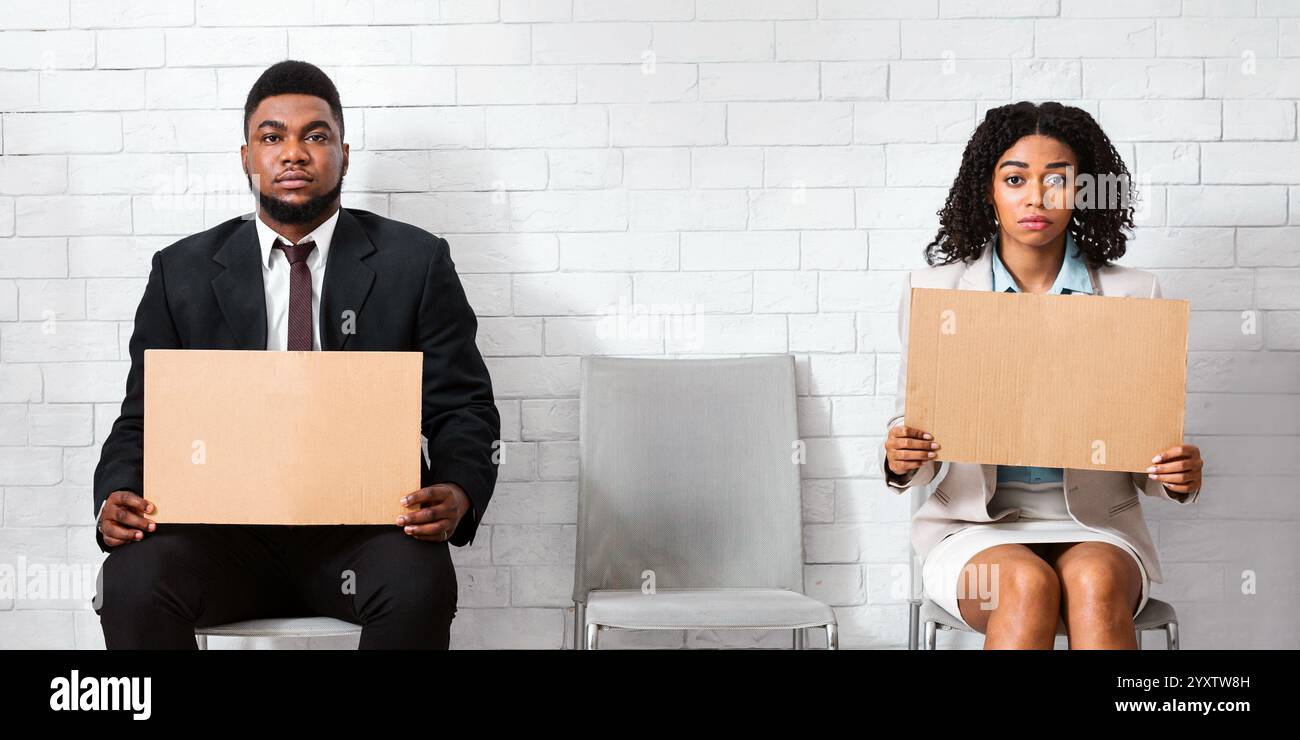 African American guy and girl with cardboard signs waiting for job ...