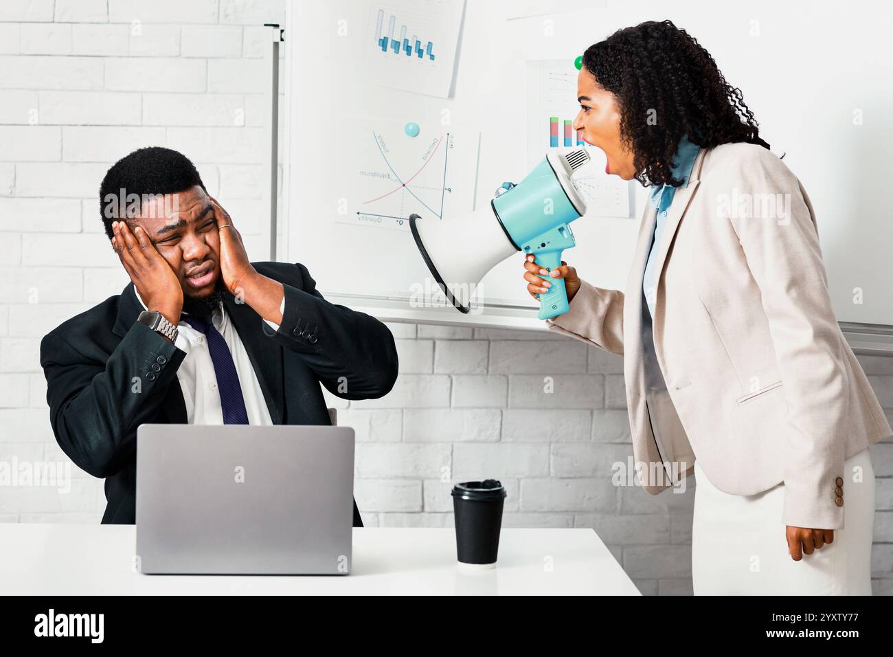 Emotional lady boss with megaphone screaming at male employee at ...