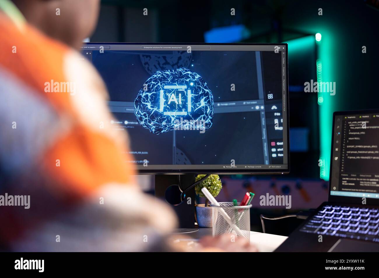 Professional male developer manages neural network at desk, working with AI code on laptop ...