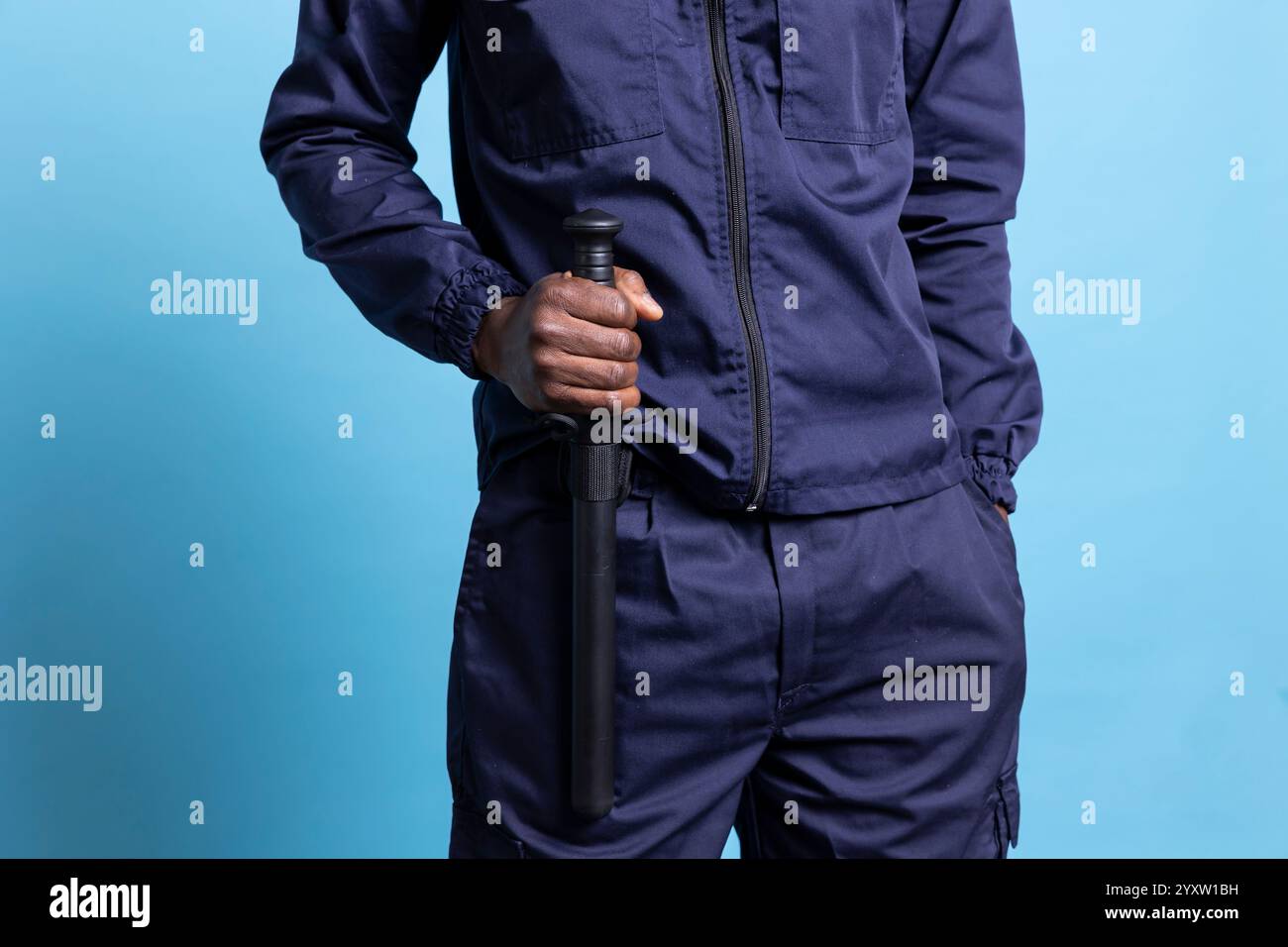 Security agent holding his baton for own safety while on duty ...