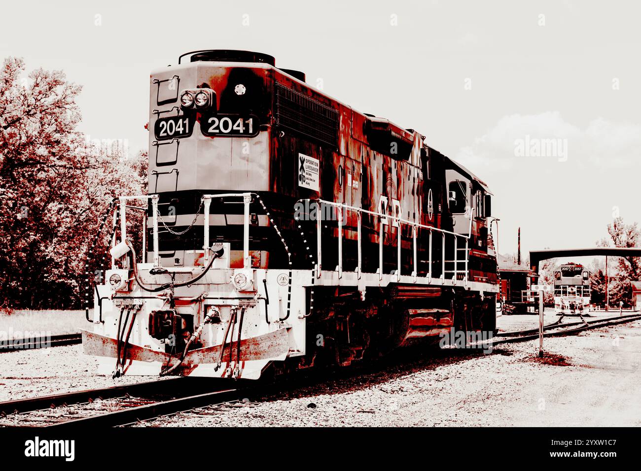 Colorful, powerful looking train engine parked in the railroad switch ...