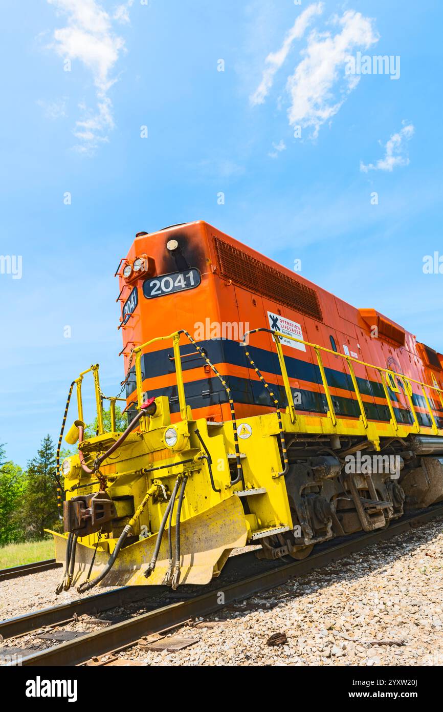Colorful, powerful looking train engine parked in the railroad switch ...