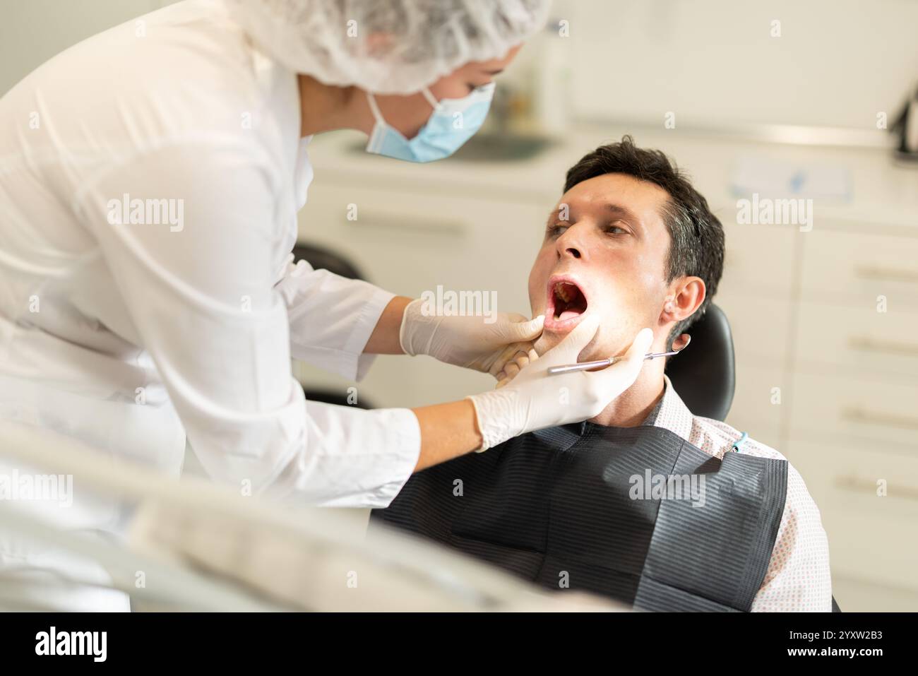 Doctor examines oral cavity hi-res stock photography and images - Alamy