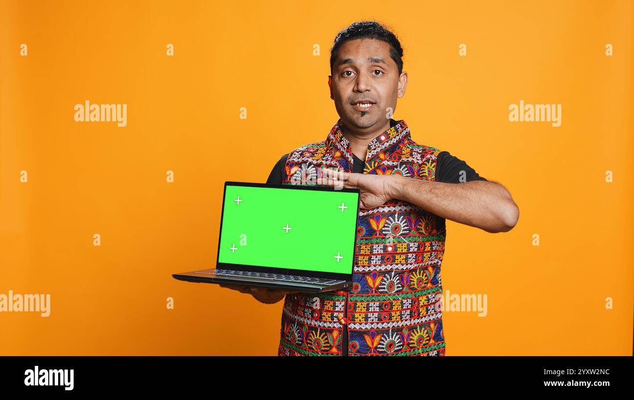 Upbeat tech specialist doing promotion using isolated screen laptop ...