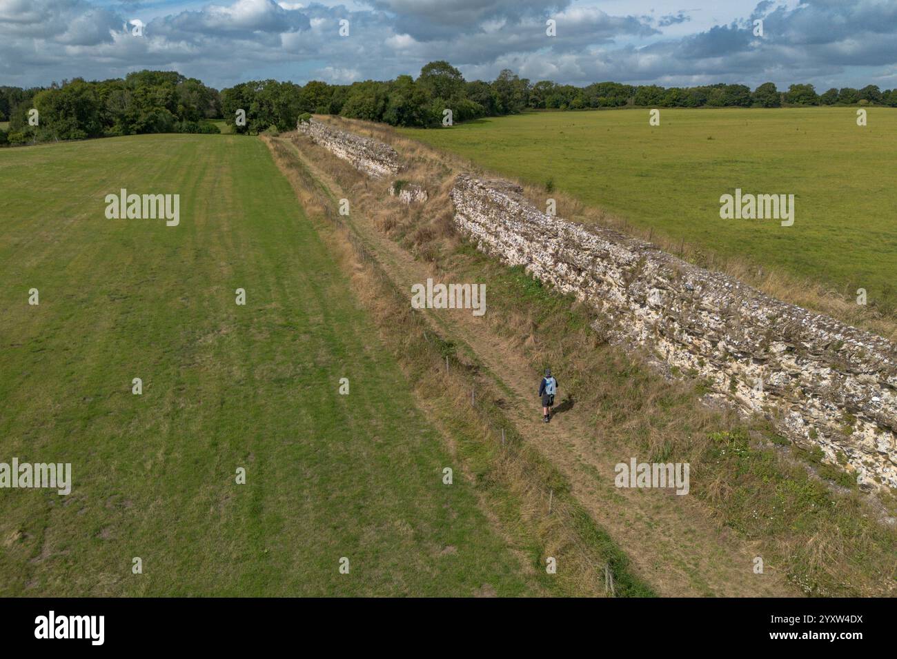 Aerial view of man walking along the south wall of the Roman city of ...