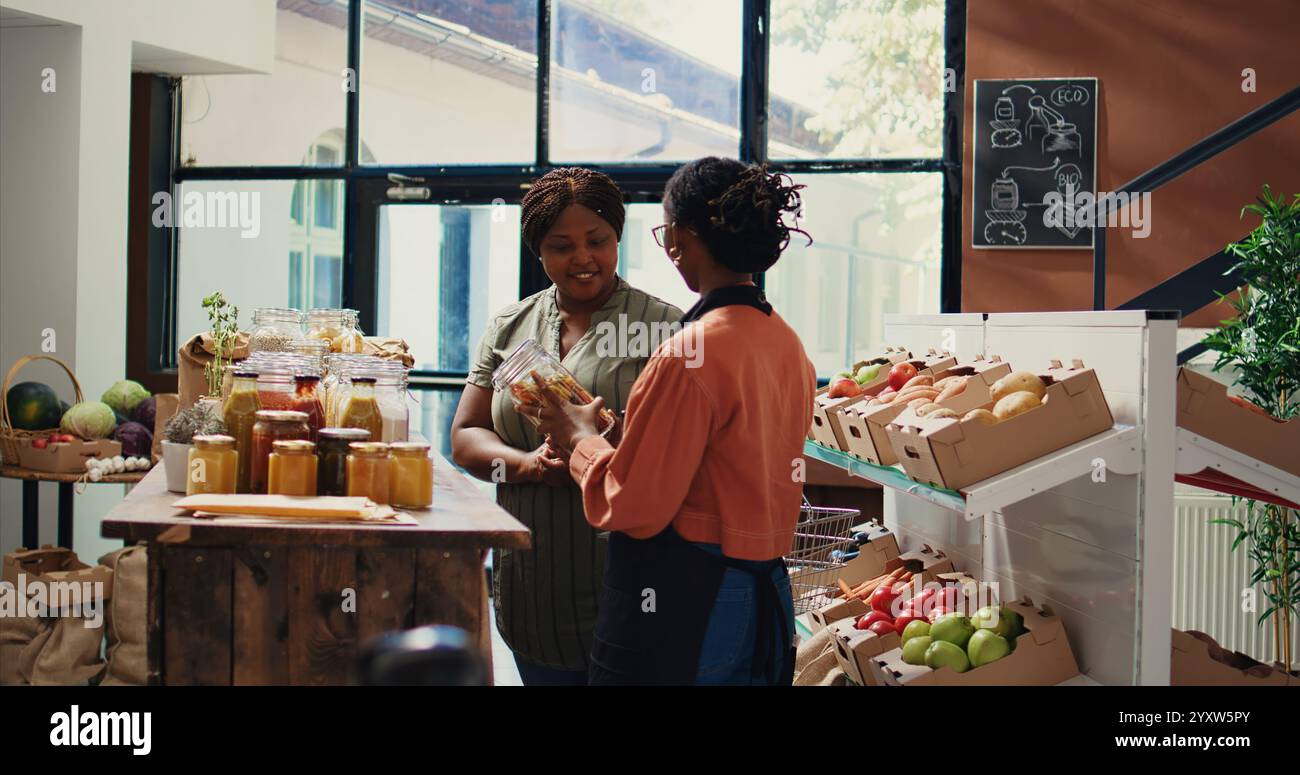 Retailer recommending types of paste for customer, showing her a ...