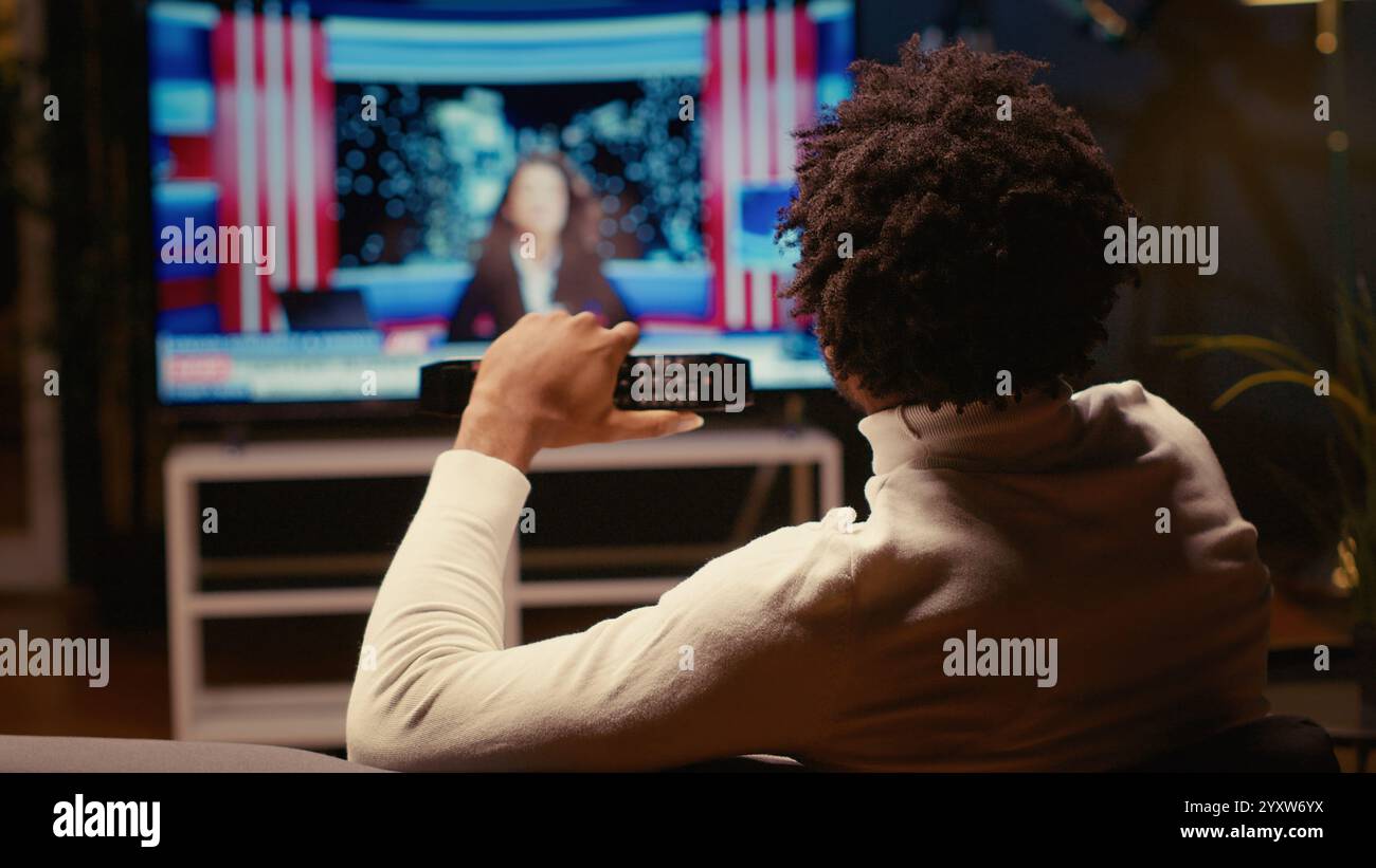 African american man reacting to latest news on TV, watching reporter ...