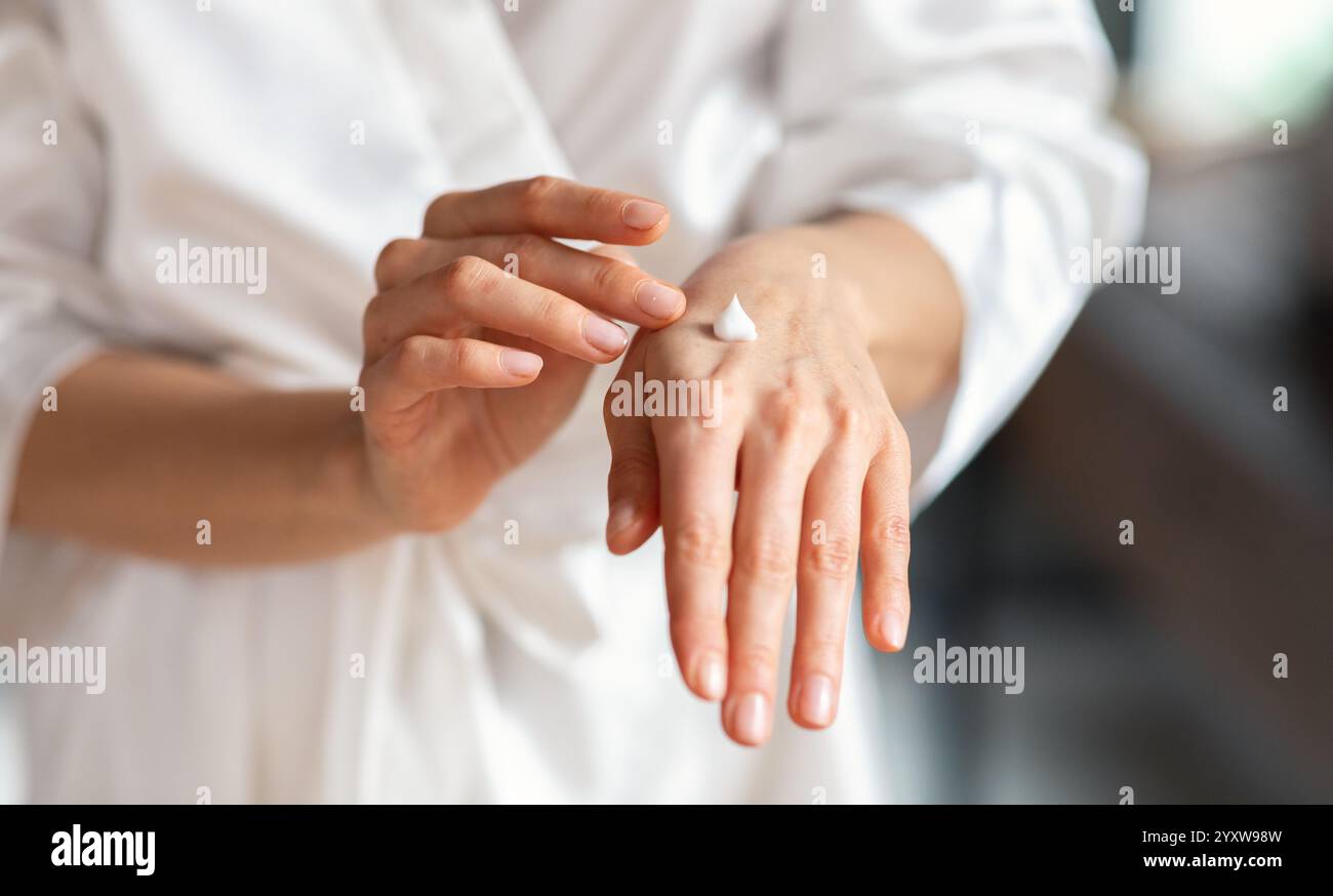 Young woman pampering herself with skin care in a modern bathroom Stock ...