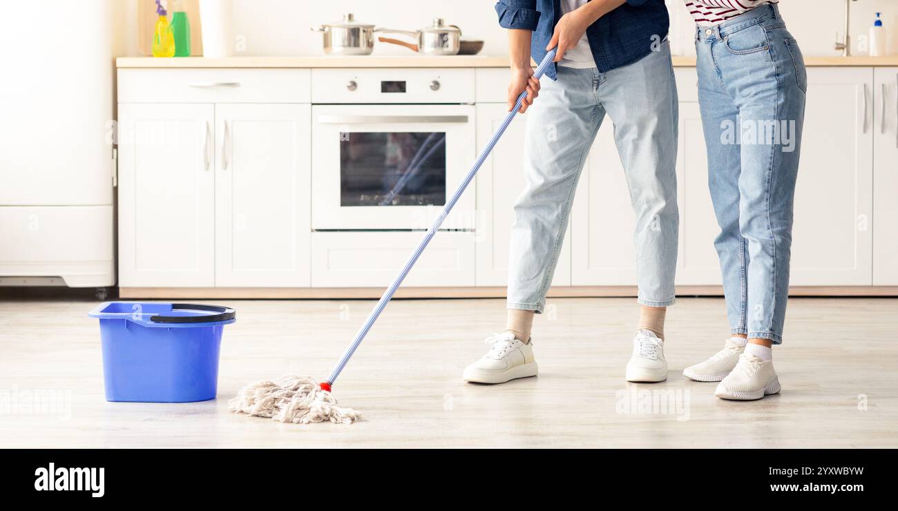 Unrecognizable man and woman cleaning kitchen, mopping floor Stock ...