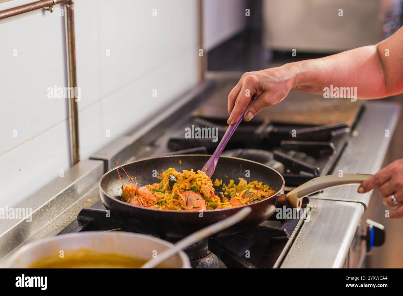 Chef preparing traditional ecuadorian seafood dish in madrid restaurant ...
