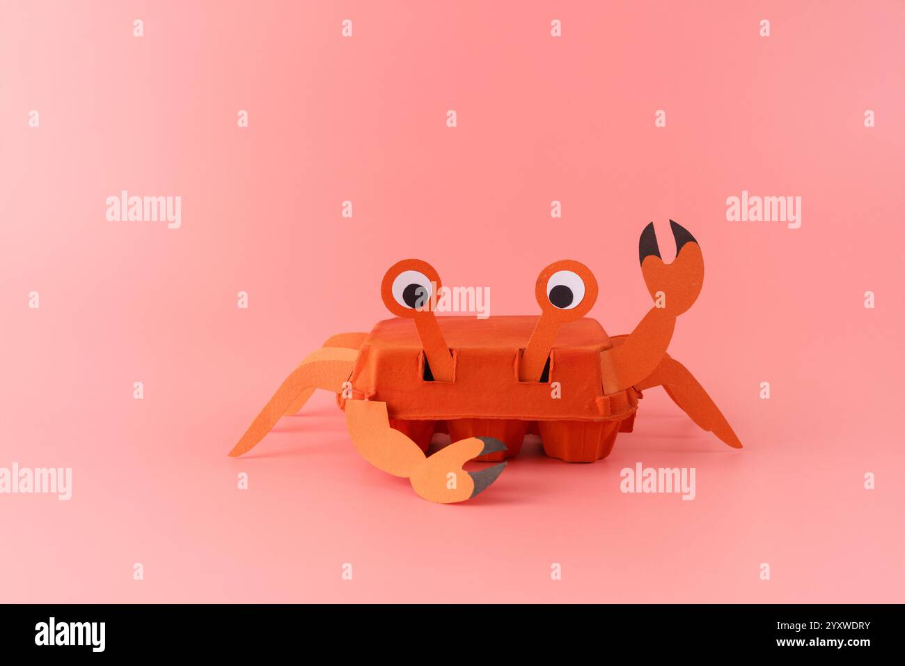 DIY crab craft made from orange painted egg carton with paper claws and ...