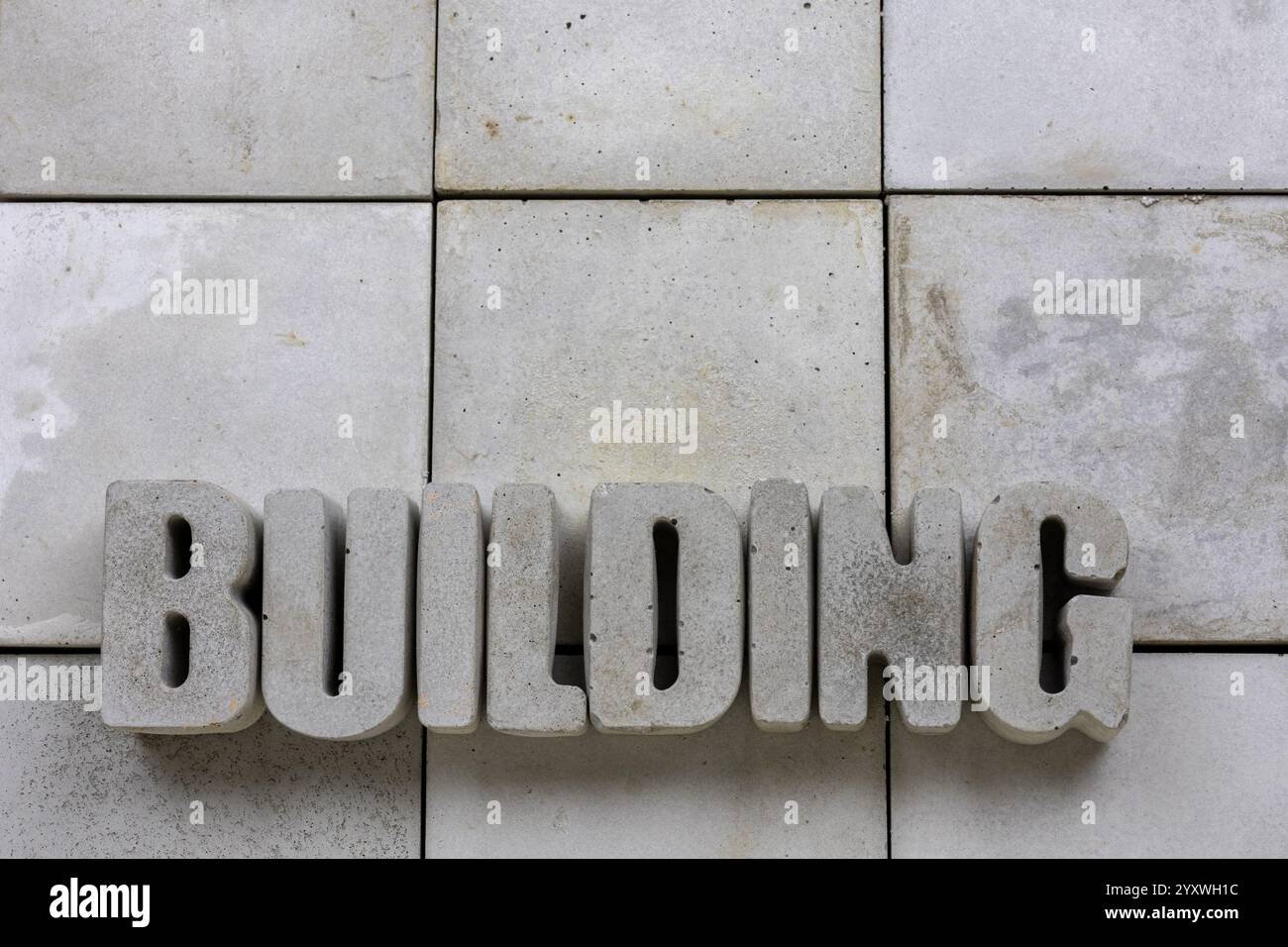 Word BUILDING in concrete letters on concrete tiled background Nice ...