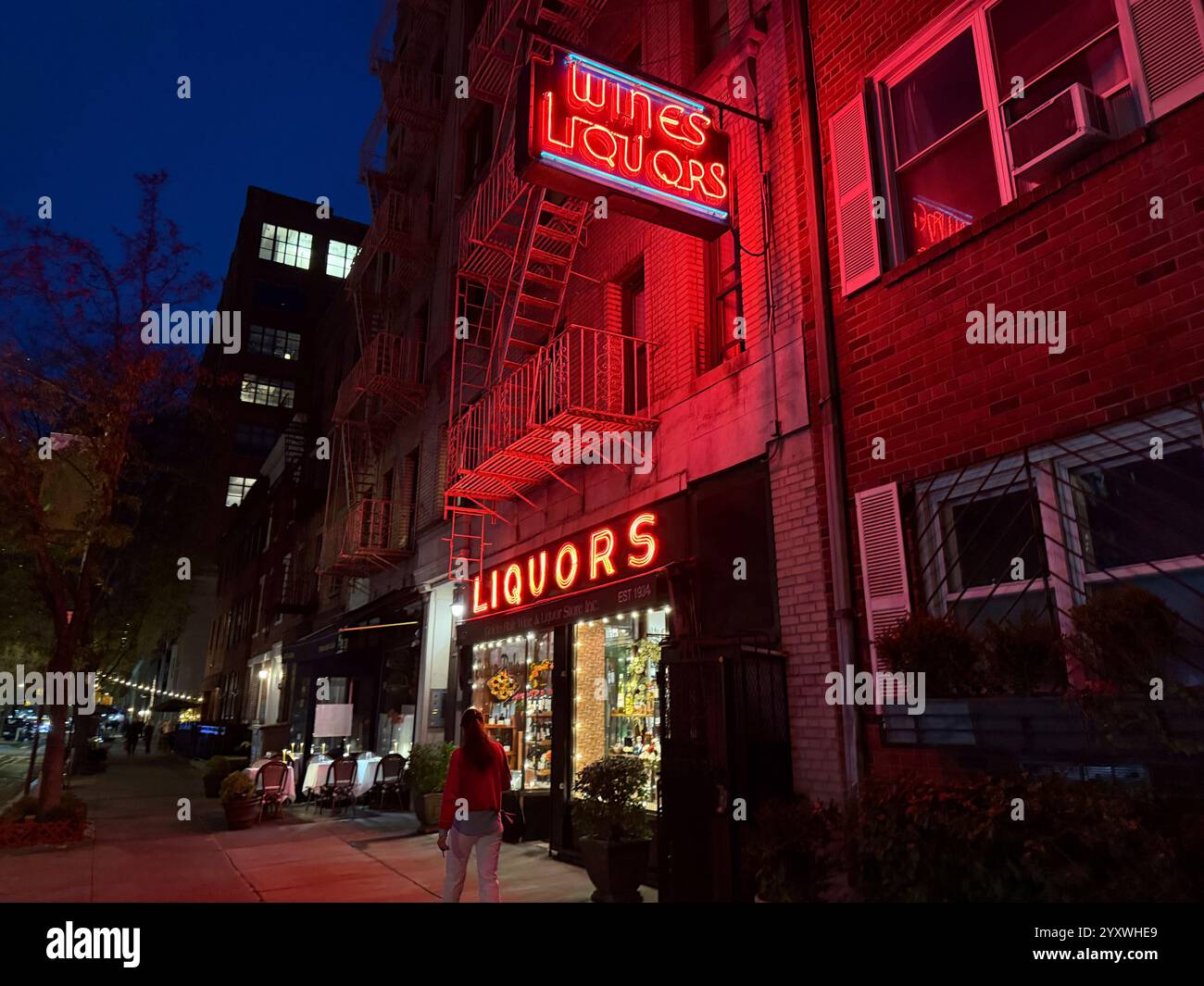 Liquor store and street scene at night, Chelsea, New York City, New ...
