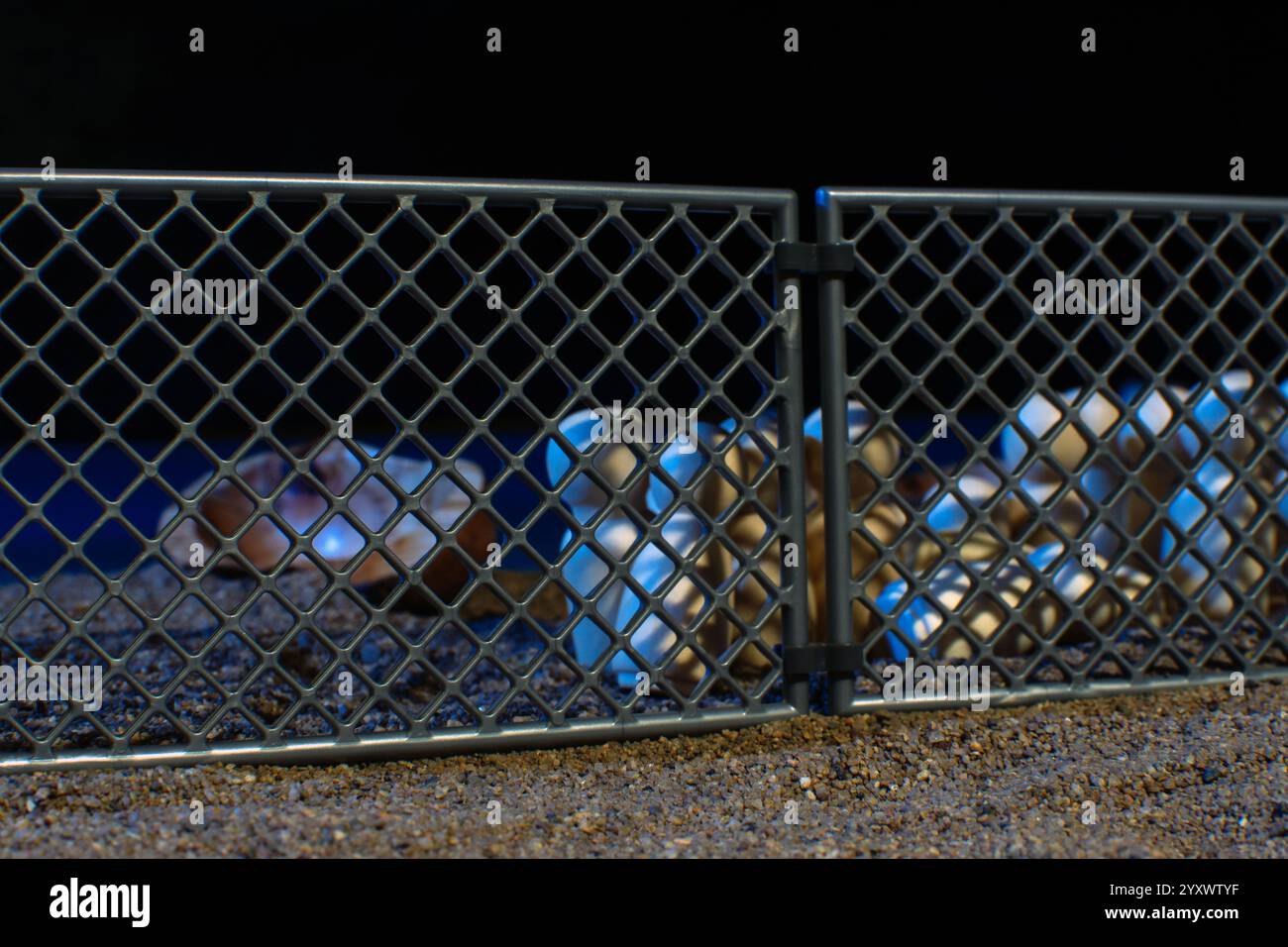 Wooden Figures Behind Metal Fence with Blue Background Stock Photo - Alamy