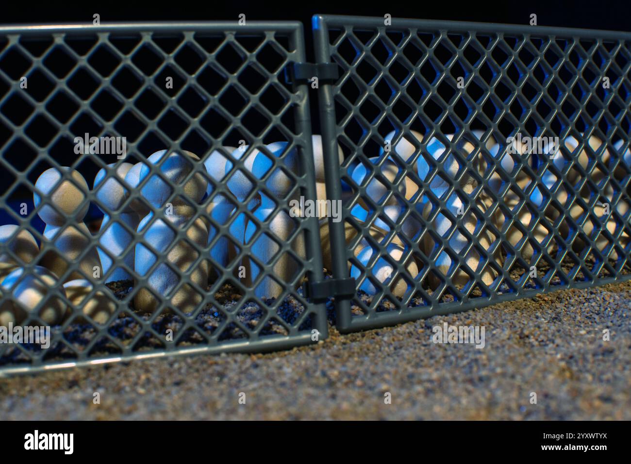 Wooden Figures Behind Metal Fence with Blue Background Stock Photo - Alamy