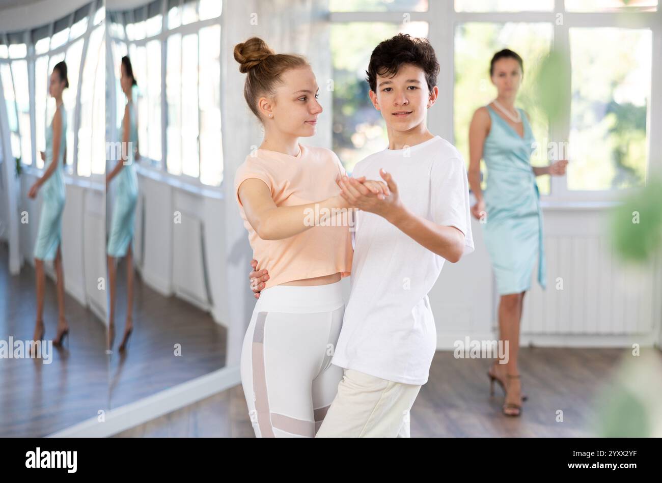 Passionate teen dancers, girl and boy practicing ballroom dancing in studio Stock Photo - Alamy