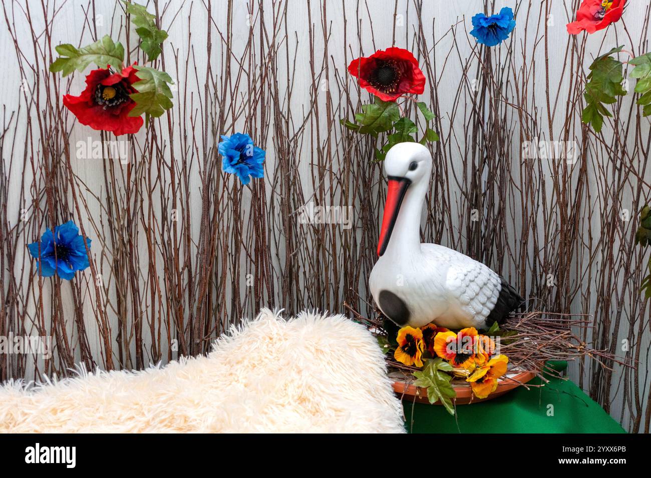 A charming indoor display showcases a white stork next to vibrant ...