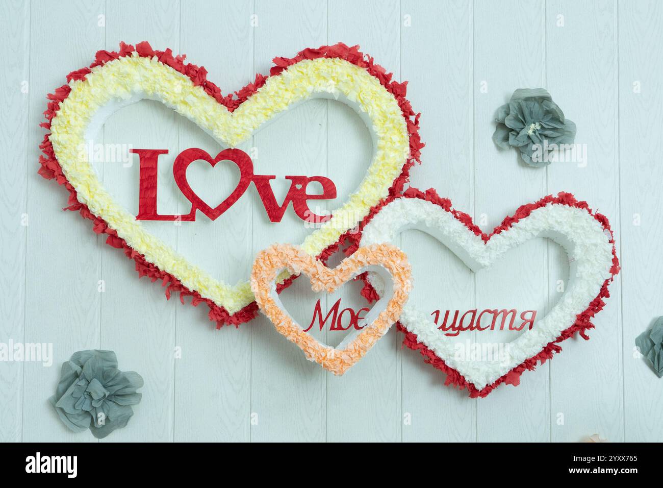 Heart-shaped decor displays the word Love in red and a message in ... Heart-shaped decor displays the word Love in red and a message in ...